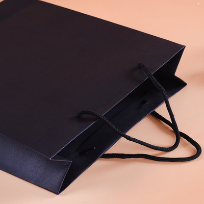 Custom printing single color black paperboard bag clothes shopping bag supplier