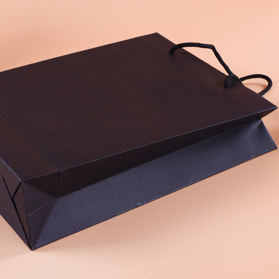 Custom printing single color black paperboard bag clothes shopping bag supplier